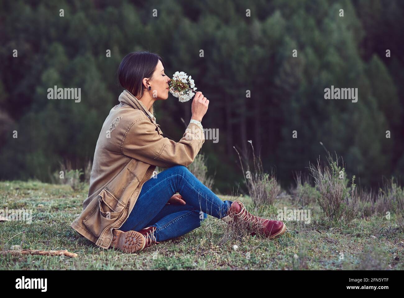 Woman on the mountain. She is in a forest with pine trees Stock Photo ...