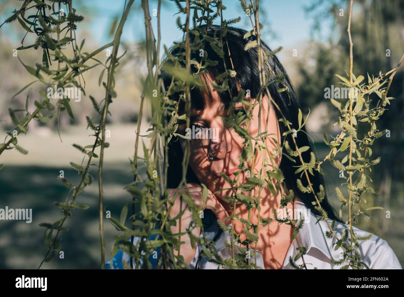 portrait of a brunette woman among trees Stock Photo - Alamy