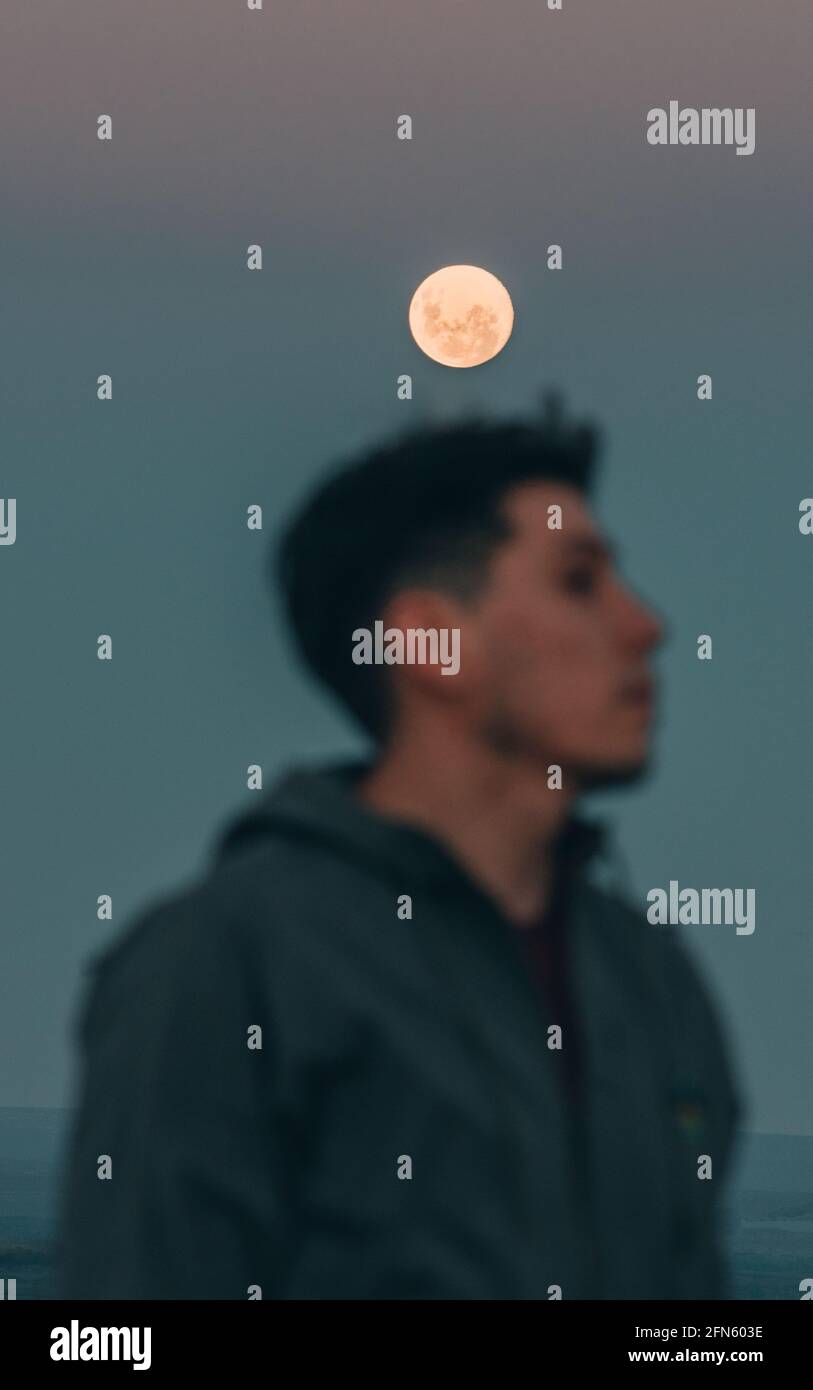 full moon with young man in blur Stock Photo - Alamy