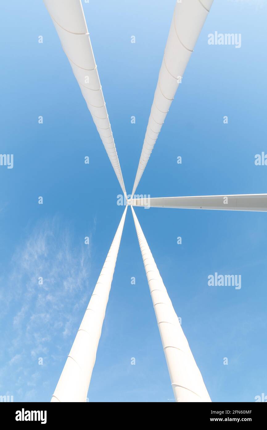 Nadir view of X-shaped white bridge braces with blue sky in background ...