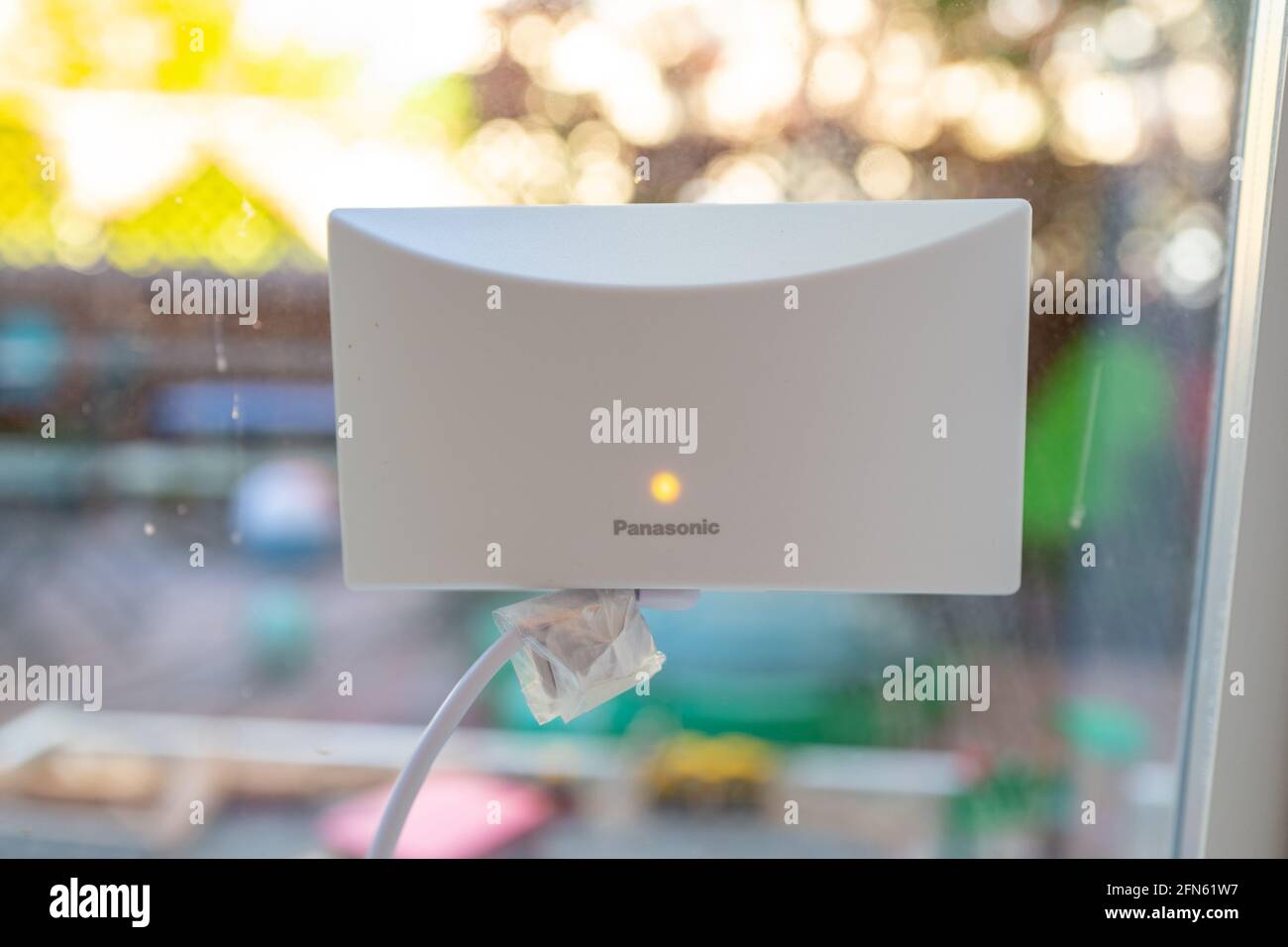 A Panasonic Homehawk Window surveillance camera is shown installed on ...