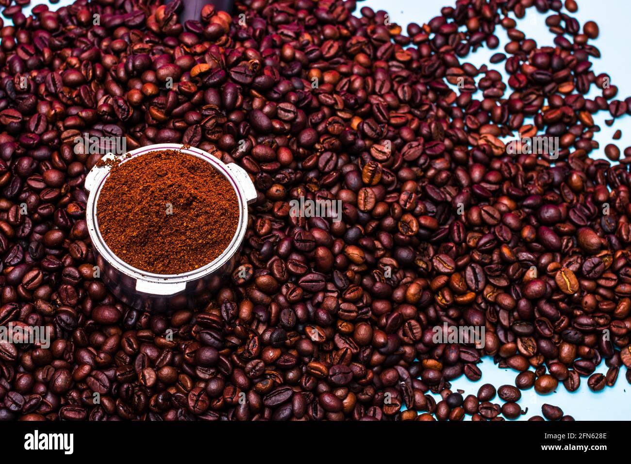 Overhead shot of roasted coffee beans and portafilter with ground ...