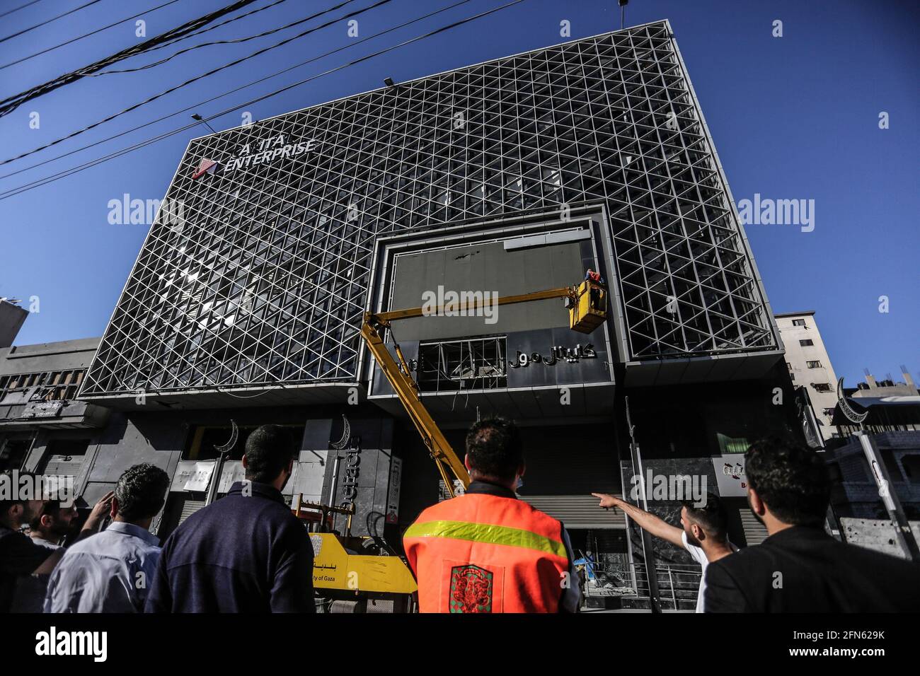 Palestinians inspect the rubble of the destroyed Al-Shorouq tower after ...