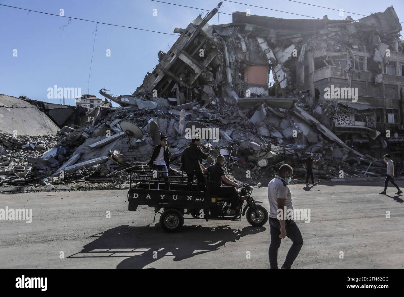 Gaza, Palestine. 13th May, 2021. Palestinians inspect the rubble of the ...
