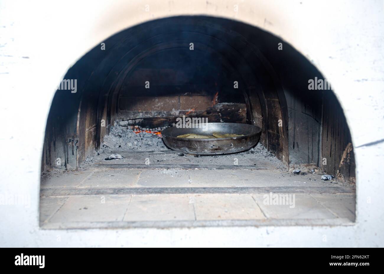 Cooking delicious traditional pies in a Russian oven outdoor Stock ...