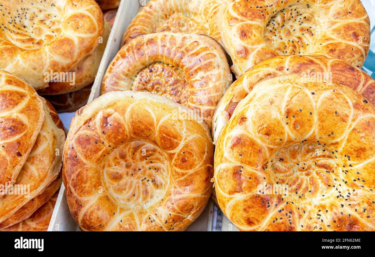 Fresh uzbek flat breads with sesame seeds from the tandir. Traditional ...