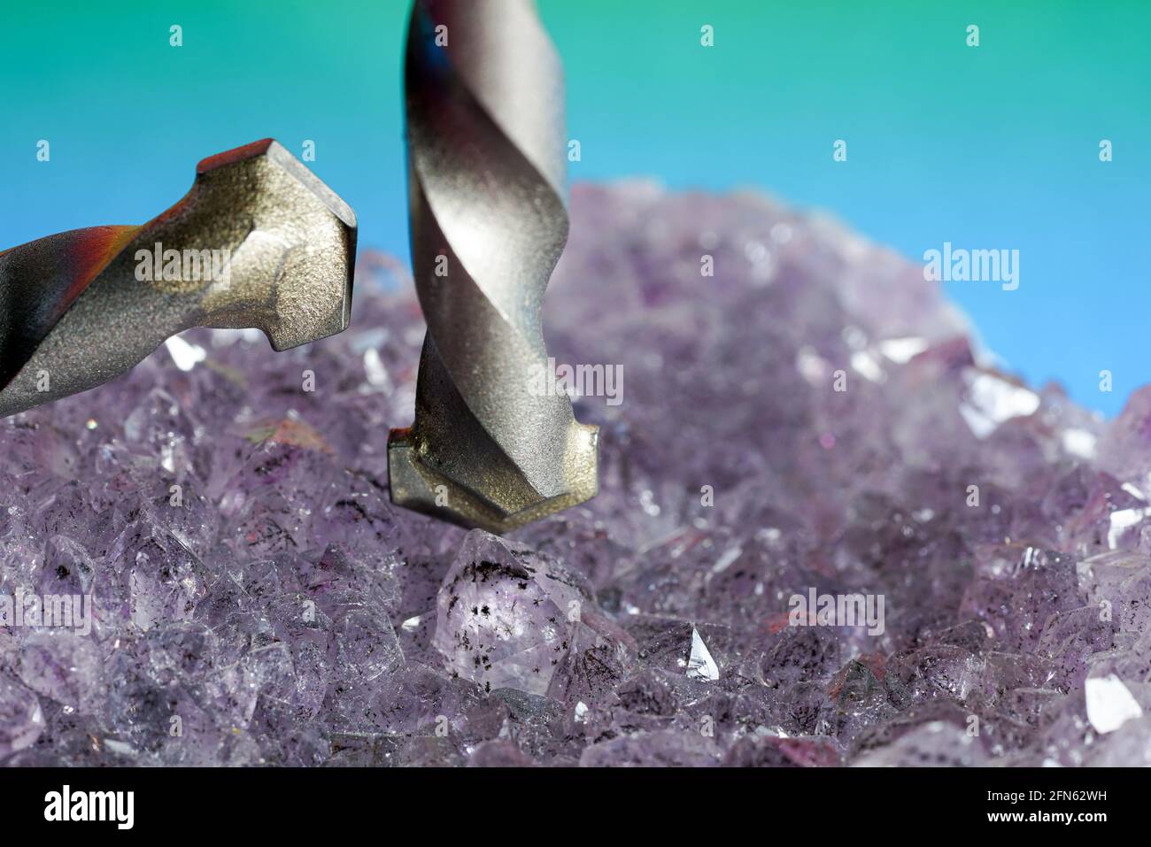 Metal drill bit ready to make holes in a crystal stone Stock Photo - Alamy
