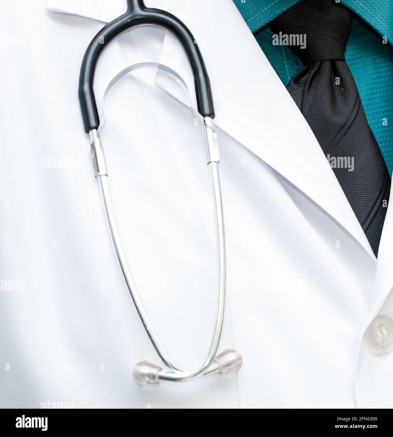Medical stethoscope on the professional's neck over the lab coat ...