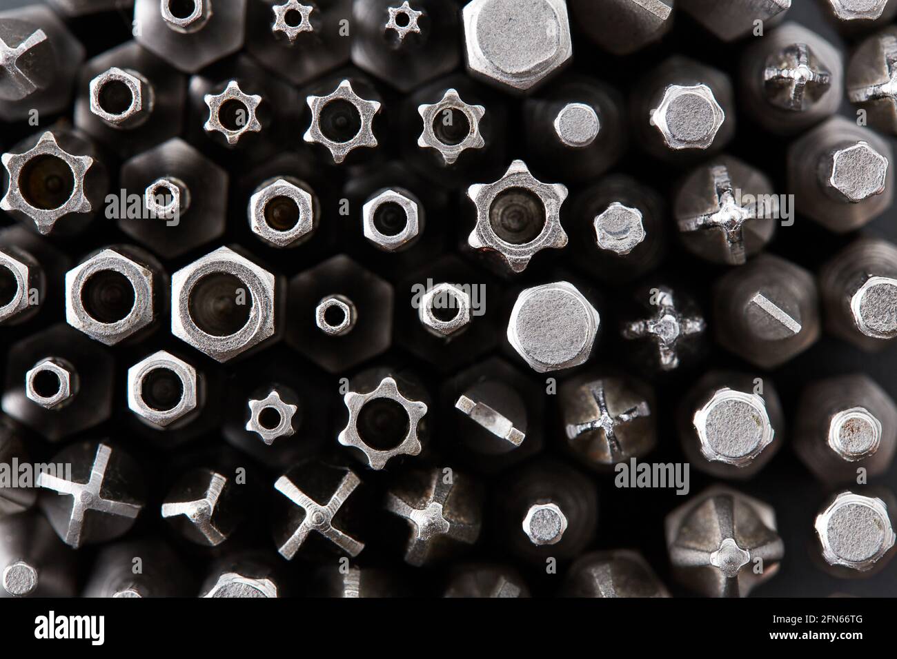 Set of heads for screwdriver. Tools collection. close up, Bits on black ...
