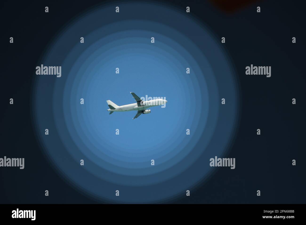 Plane flying high in sky. View to air liner flying in blue sky ...