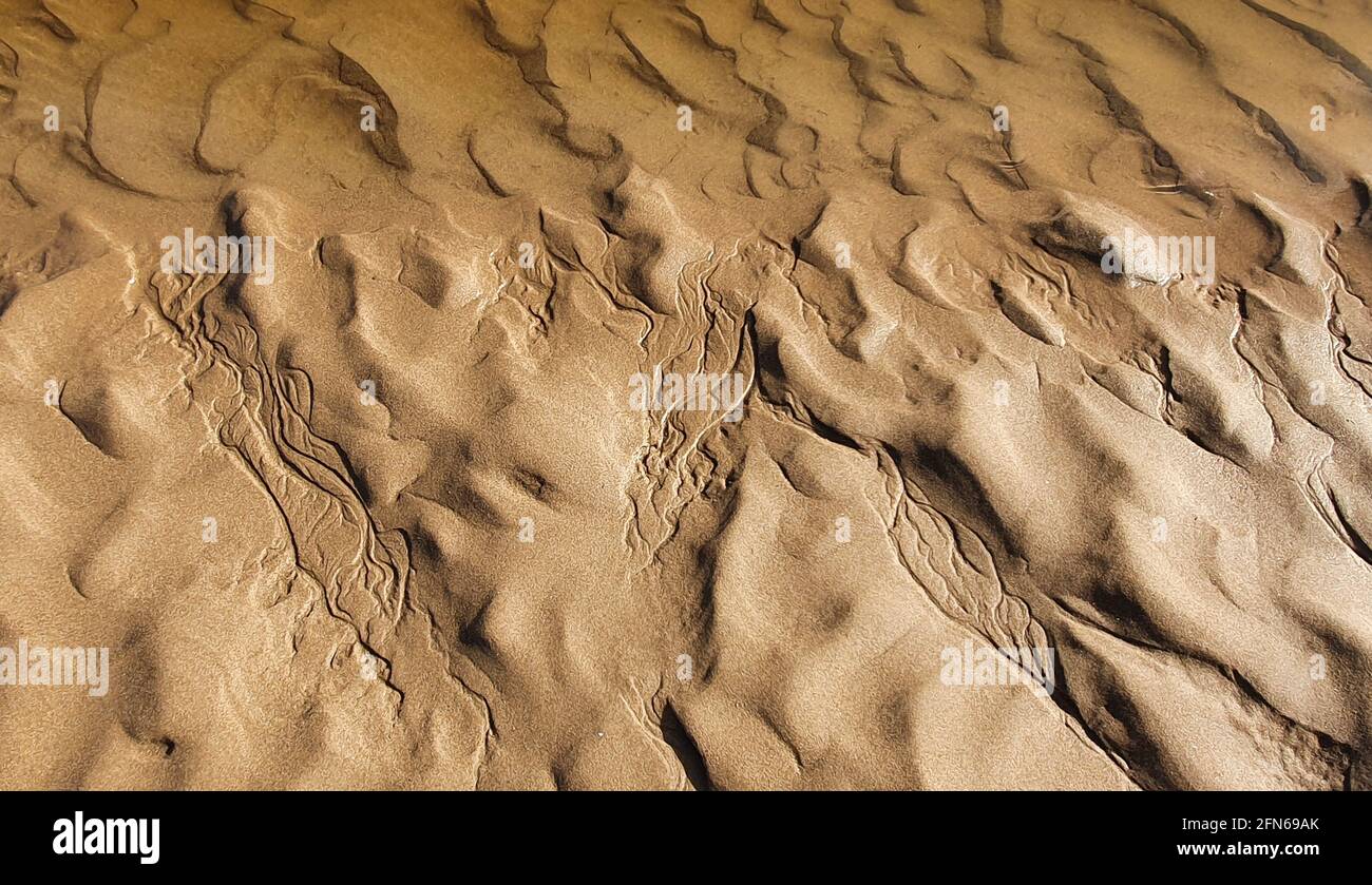 Patterns and textures in sand Stock Photo - Alamy