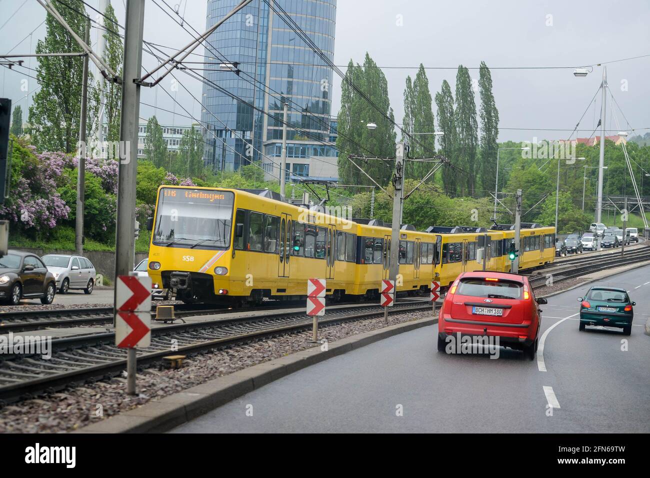 STUTTGART, GERMANY - June, 2016: The yellow, long tram goes up the hill ...