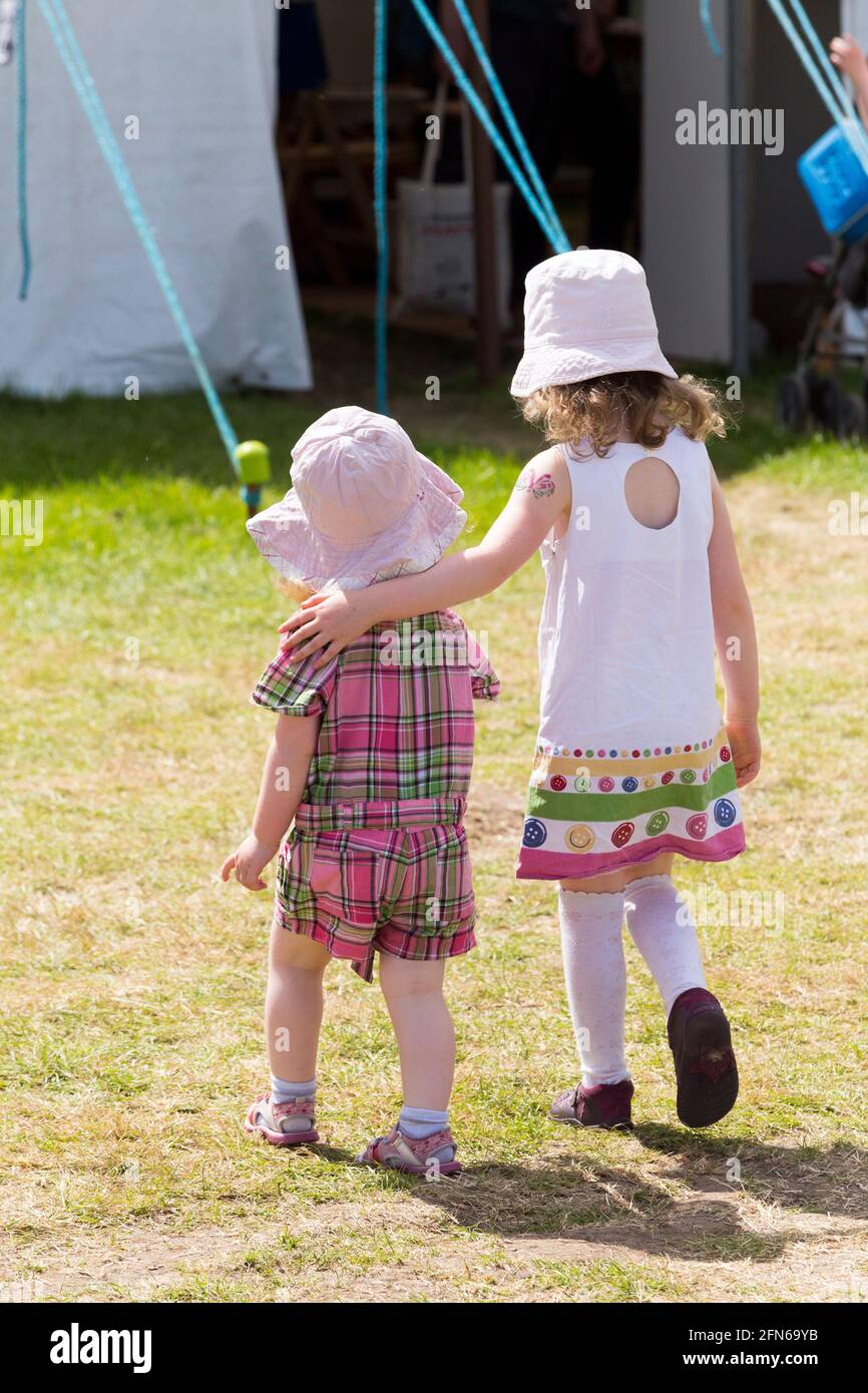 Two girls with arms around each other hi-res stock photography and ...