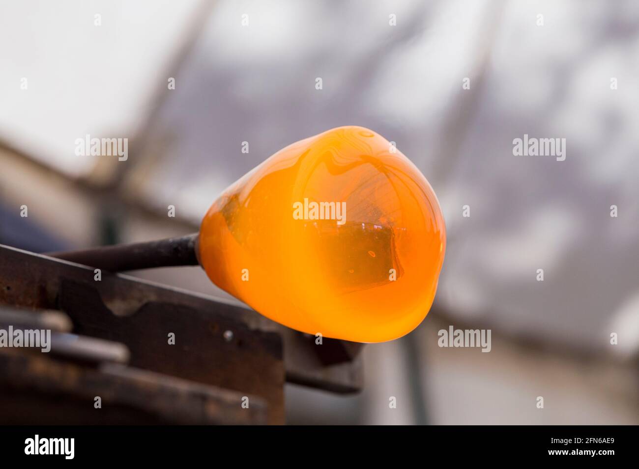 A glass blower's pipe with a gob (or blob) of molten glass on the end ...