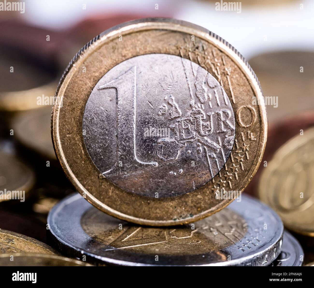 Beautiful one euro coin standing on pile Stock Photo - Alamy