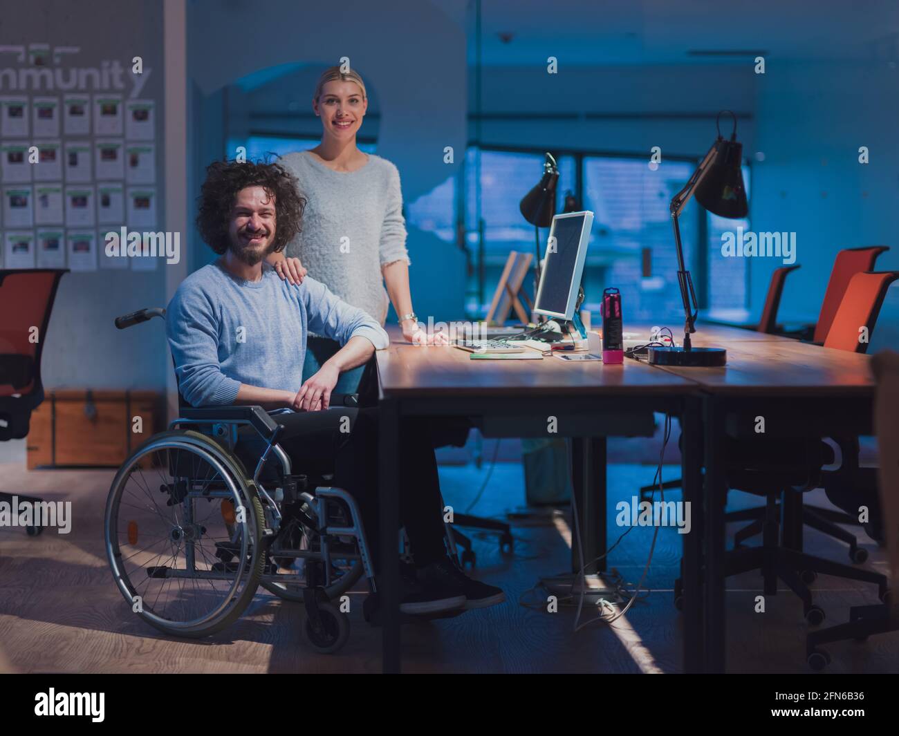 Businessman in a wheelchair in modern coworking office space working ...