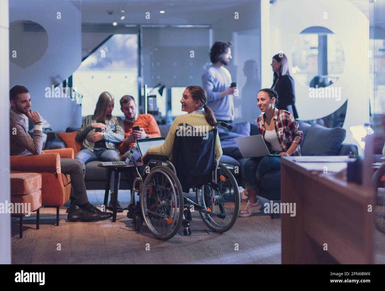 Handicapperd businesswoman in a wheelchair on meeting with her diverse ...