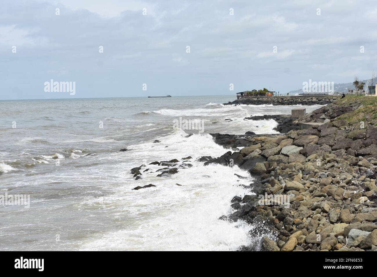 High angle shot of a wavy ocean and beach with rocks Stock Photo - Alamy