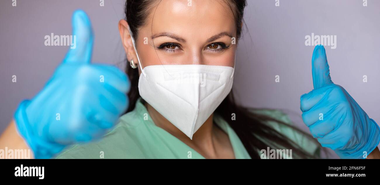 Young medical professional, nurse with protective mask and smiling eyes ...