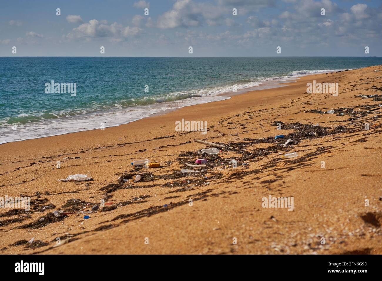 Poured trash on the beach - empty used dirty plastic bottles, packages ...