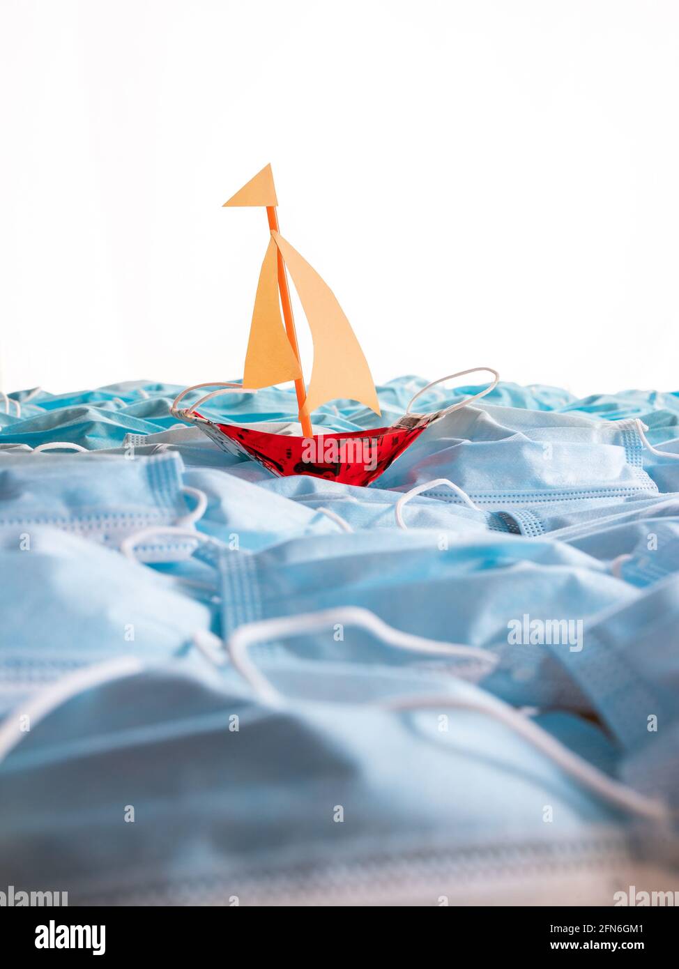 Safety surgical masks arrangement with metaphor of sailing boat on ...