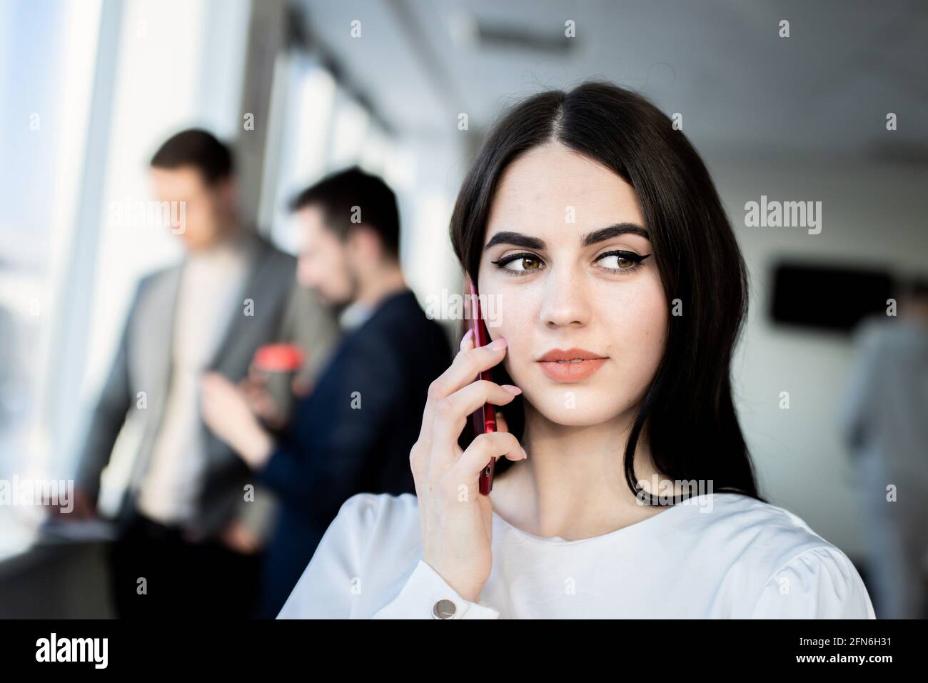 Business lady in the office talking on a phone Stock Photo - Alamy