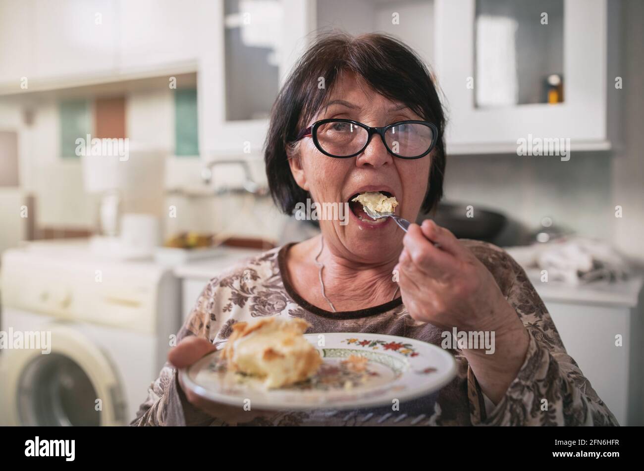 Overweight woman eating cake hi-res stock photography and images - Alamy