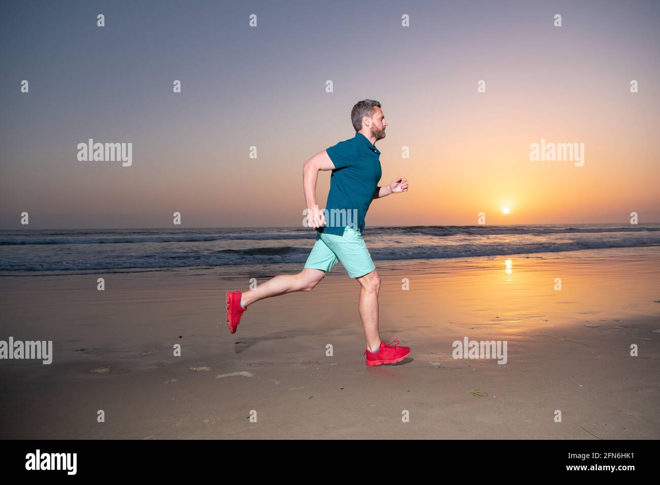 Athletic young man running. Fit male fitness runner during outdoor ...