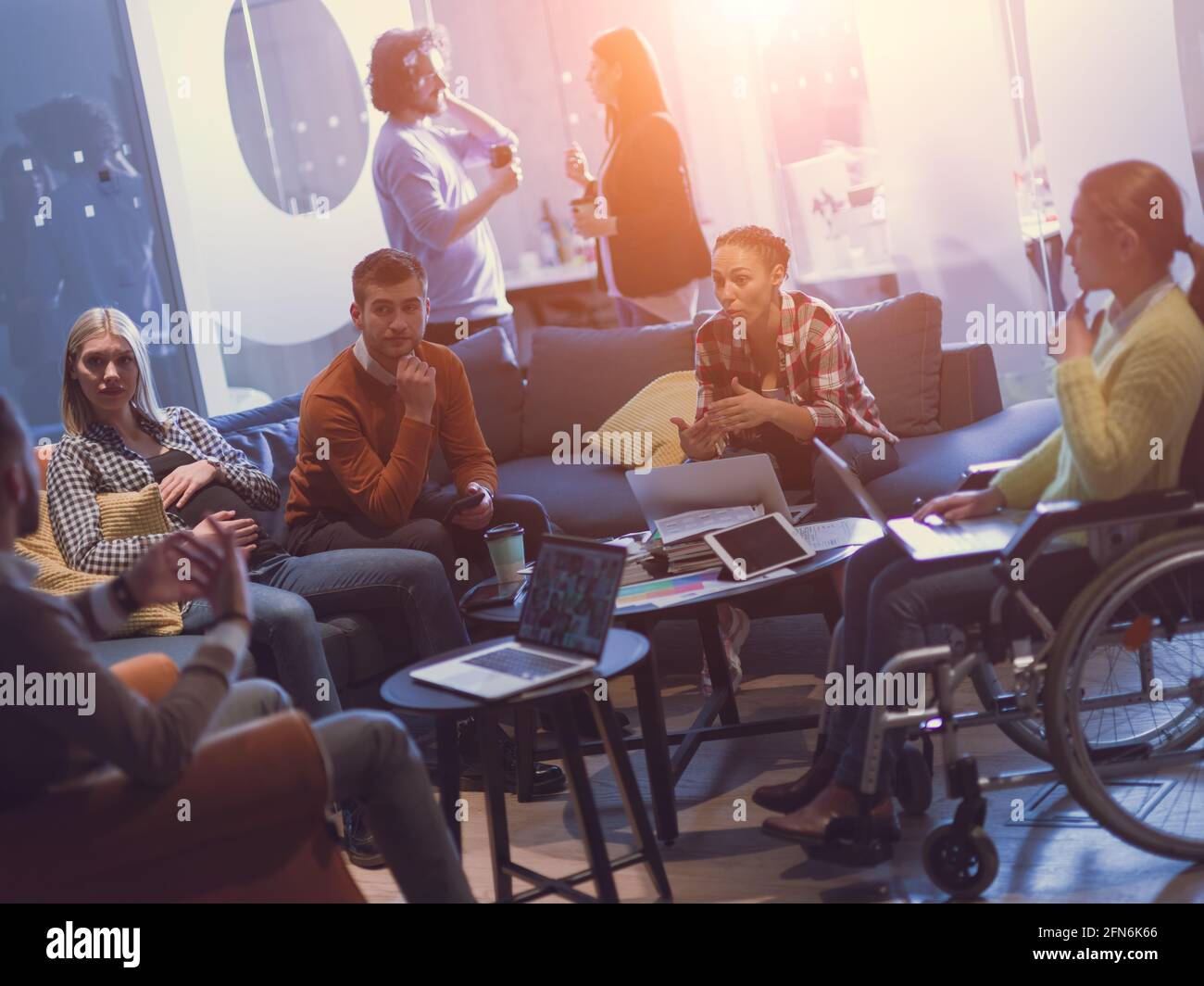 Handicapperd businesswoman in a wheelchair on meeting with her diverse ...