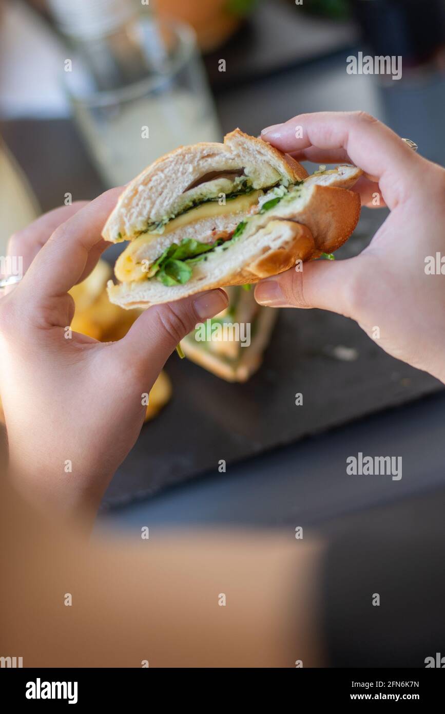 hands holding a sandwich about to eat Stock Photo - Alamy