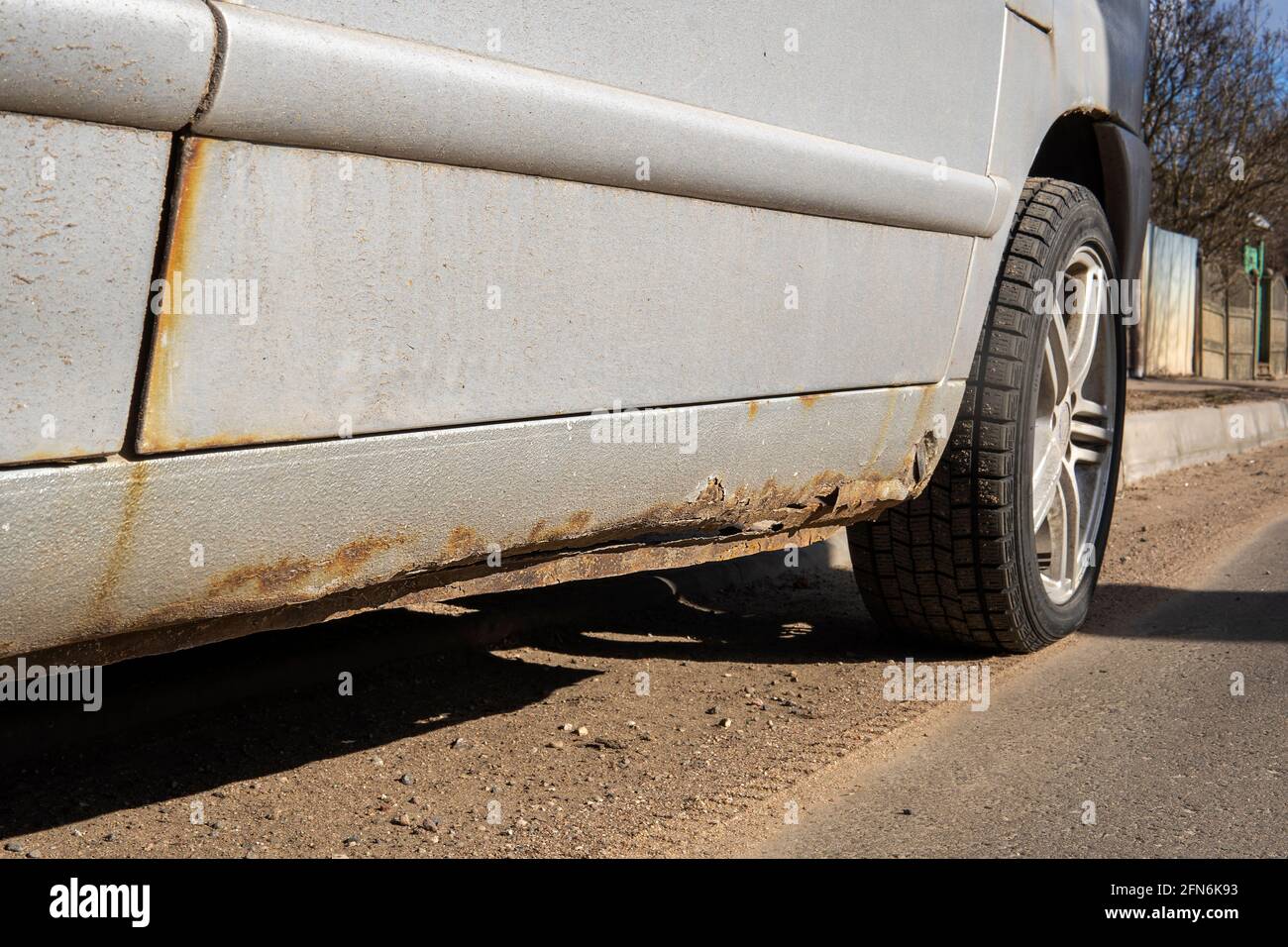Sheet metal corrosion over wheel of old white car. Rusty messy surface ...