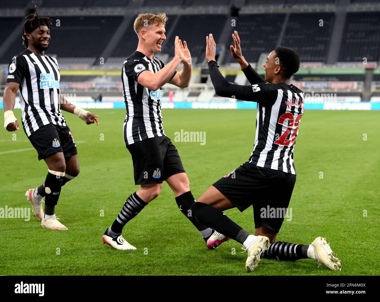 Newcastle United's Joe Willock (right) celebrates scoring their side's ...
