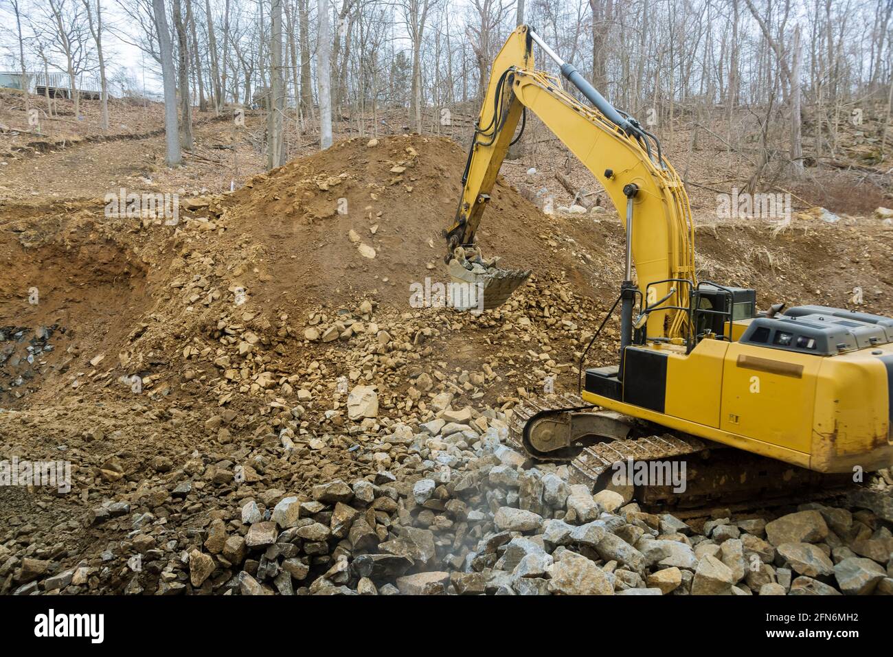 Excavator unload gravel loader with a bucket filled with crushed stone ...