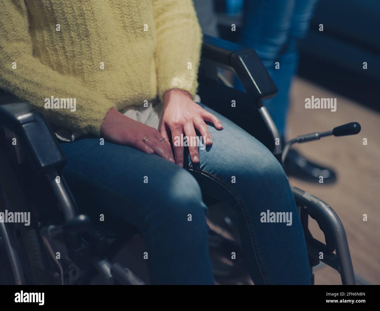 Sad and depressed disabled businesswoman in a wheelchair at the office ...