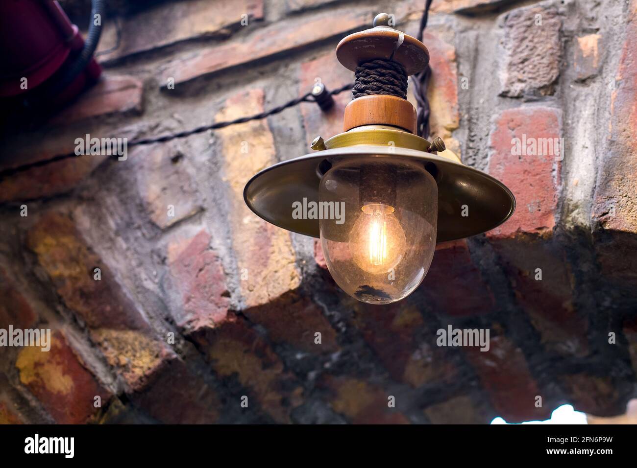 retro street light lantern on brick wall with edison electric lamp ...