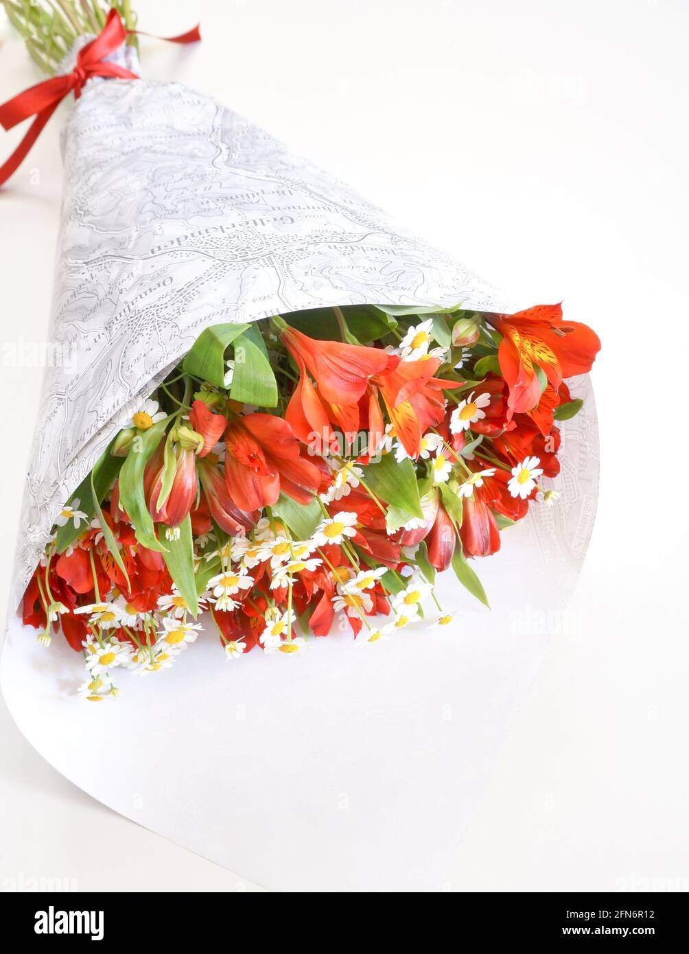 Bouquet of red flowers and daisy wheel camomile on sunlight Stock Photo ...