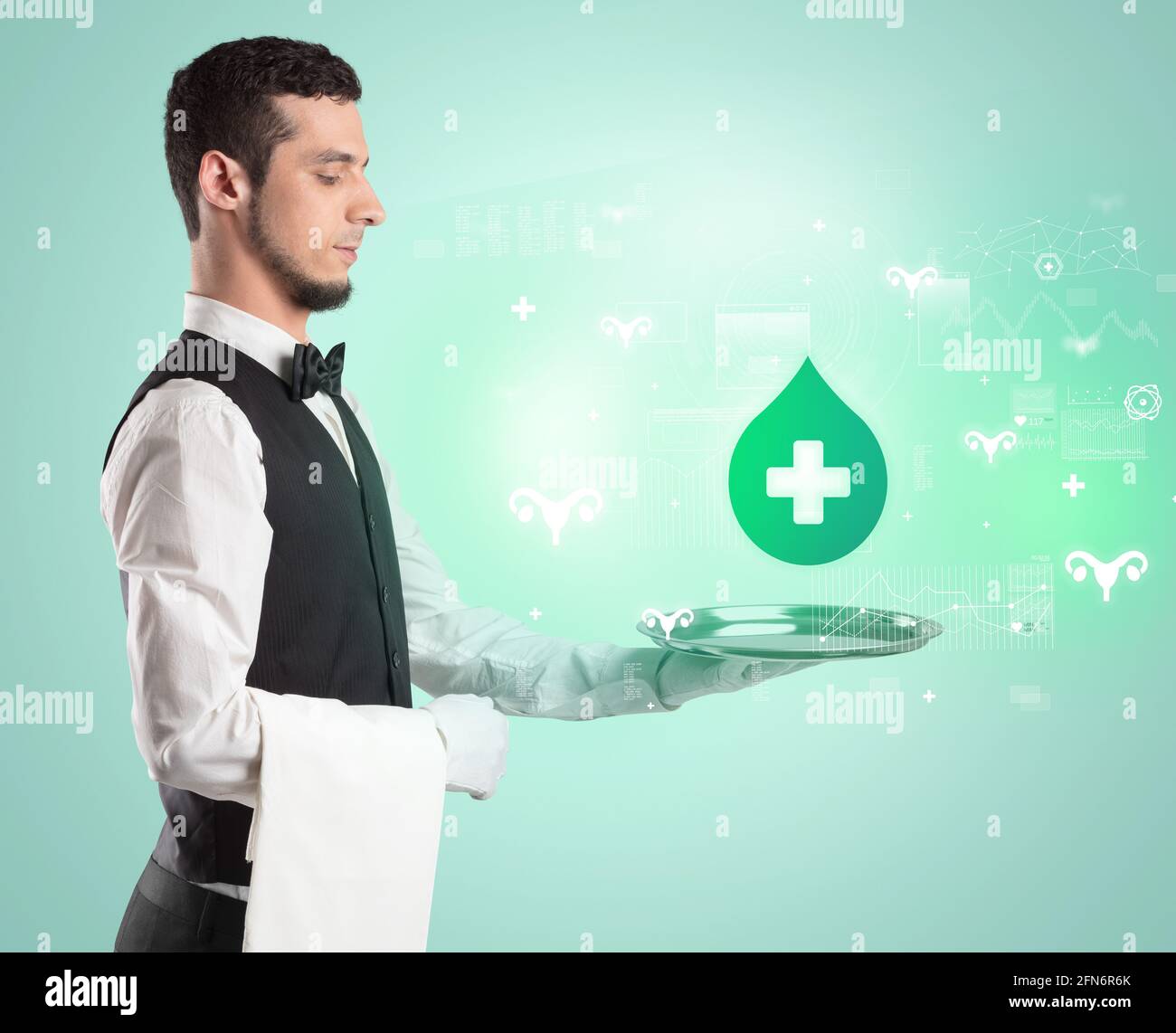 Handsome young waiter in tuxedo holding healthcare icons on tray Stock ...