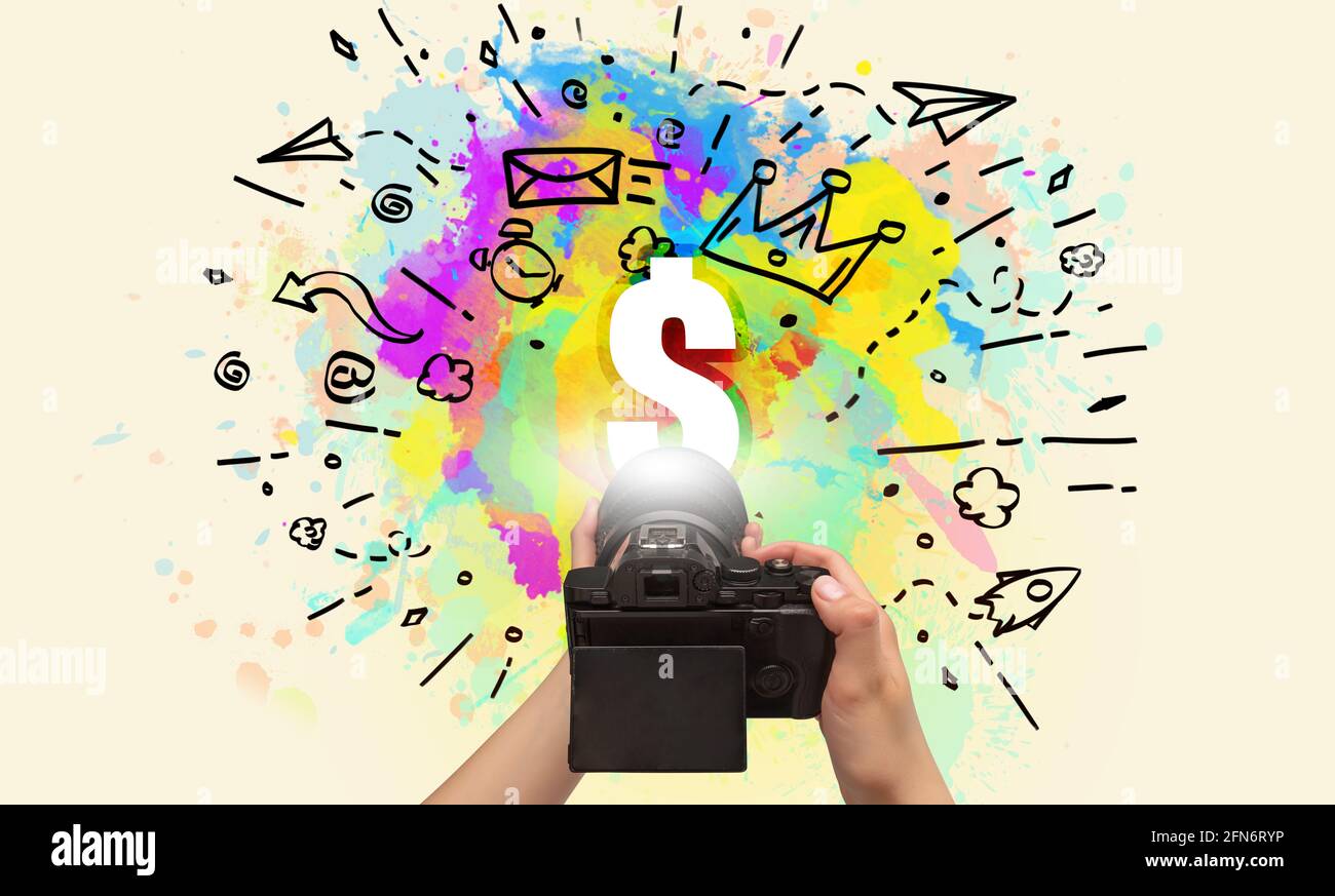 Close-up of a hand holding digital camera with abstract drawing concept ...