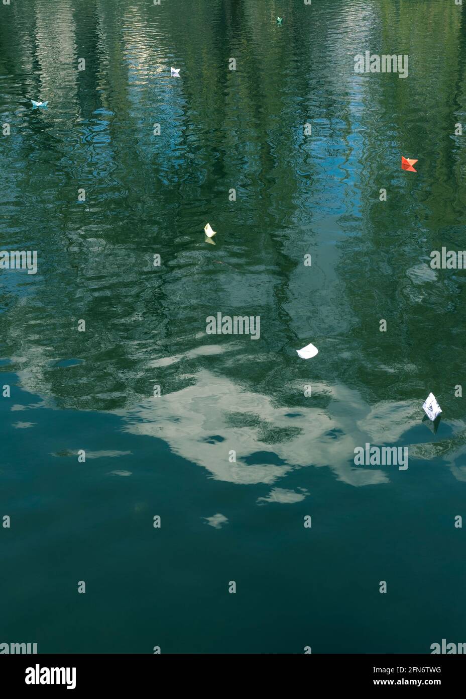 Many paper boats float on the water. Origami Stock Photo - Alamy