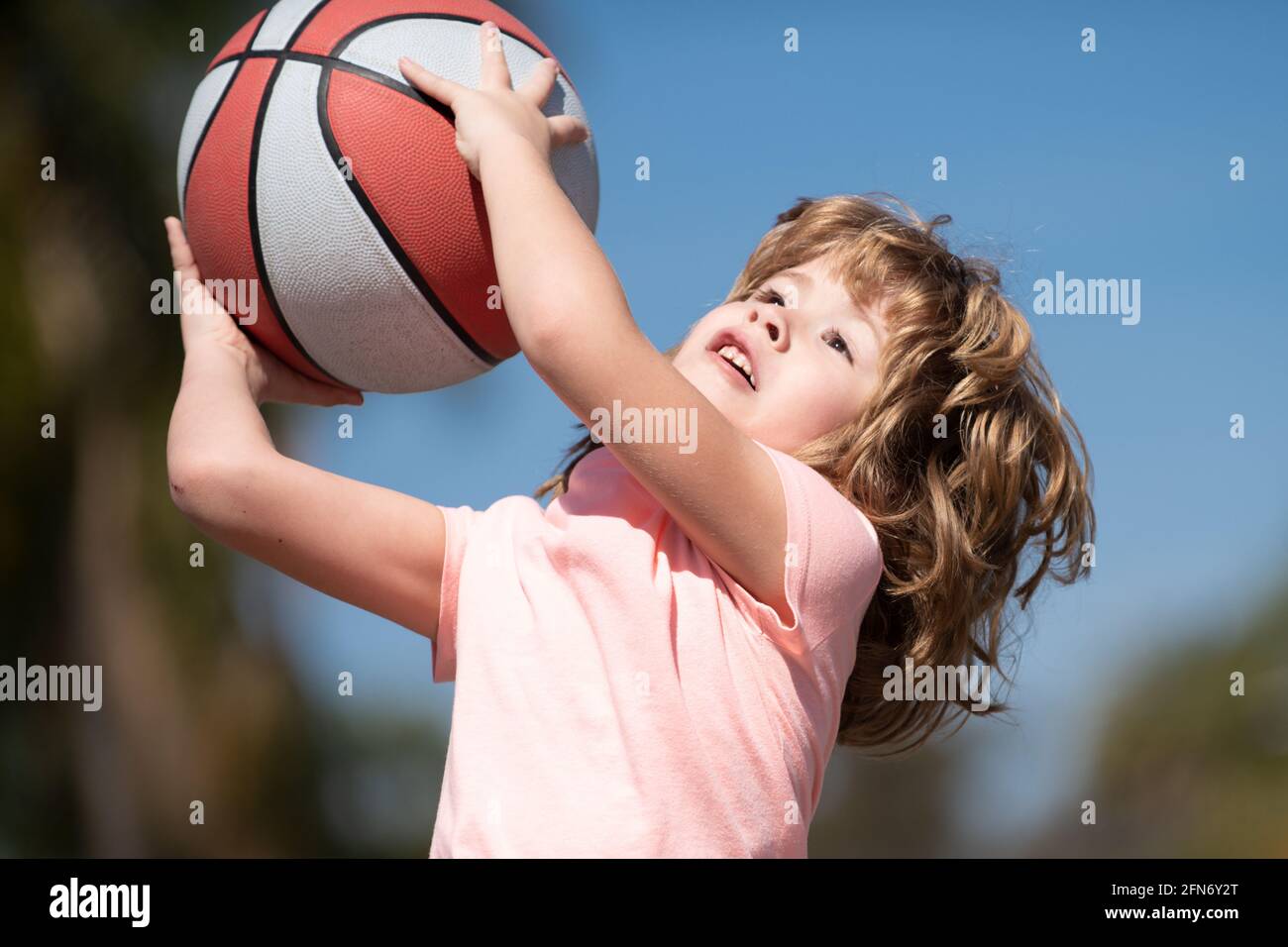 Happy little boy kid playing basketball on playground. Sport for kids ...