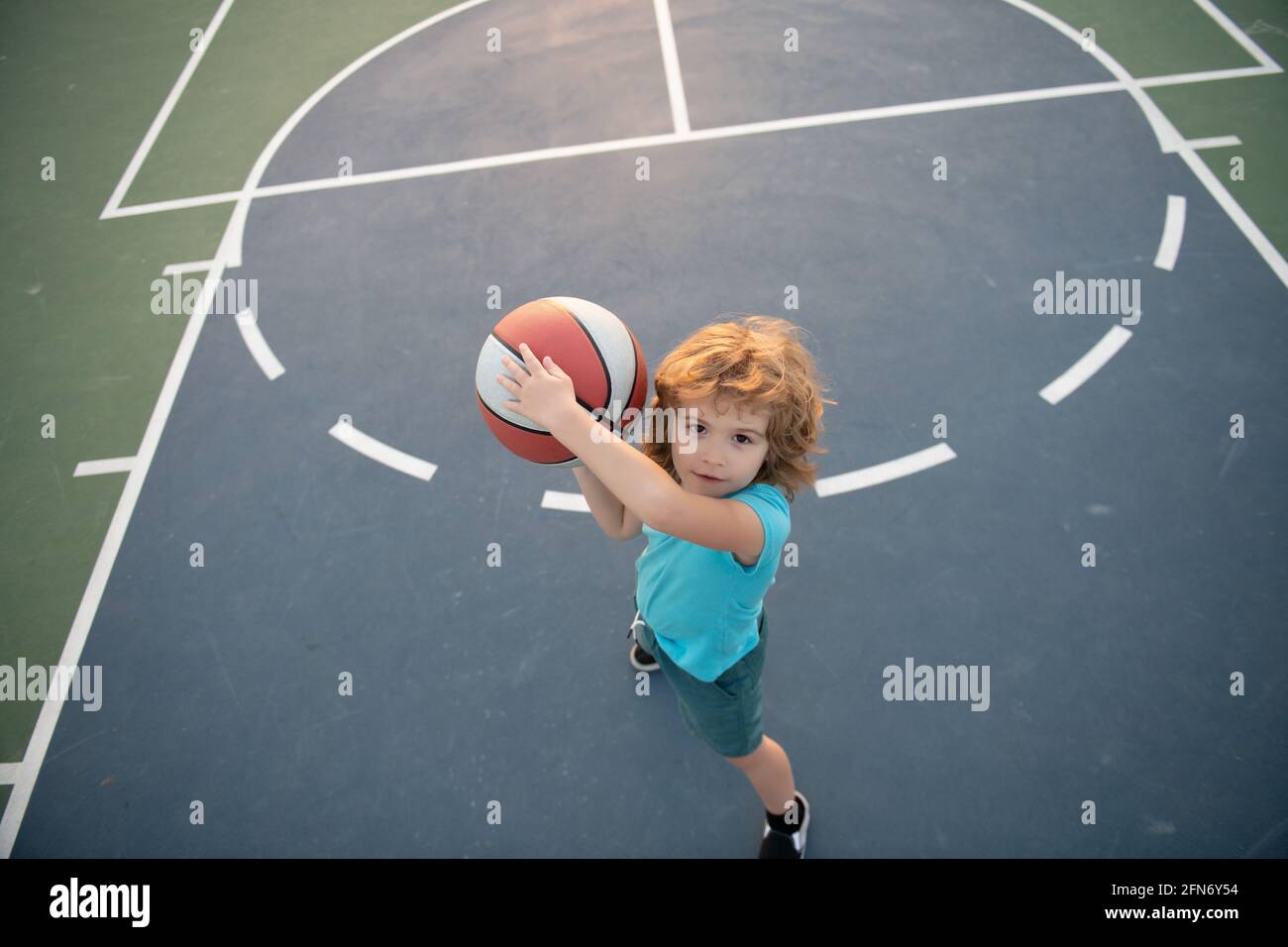 Little child boy playing basketball with basket ball Stock Photo - Alamy
