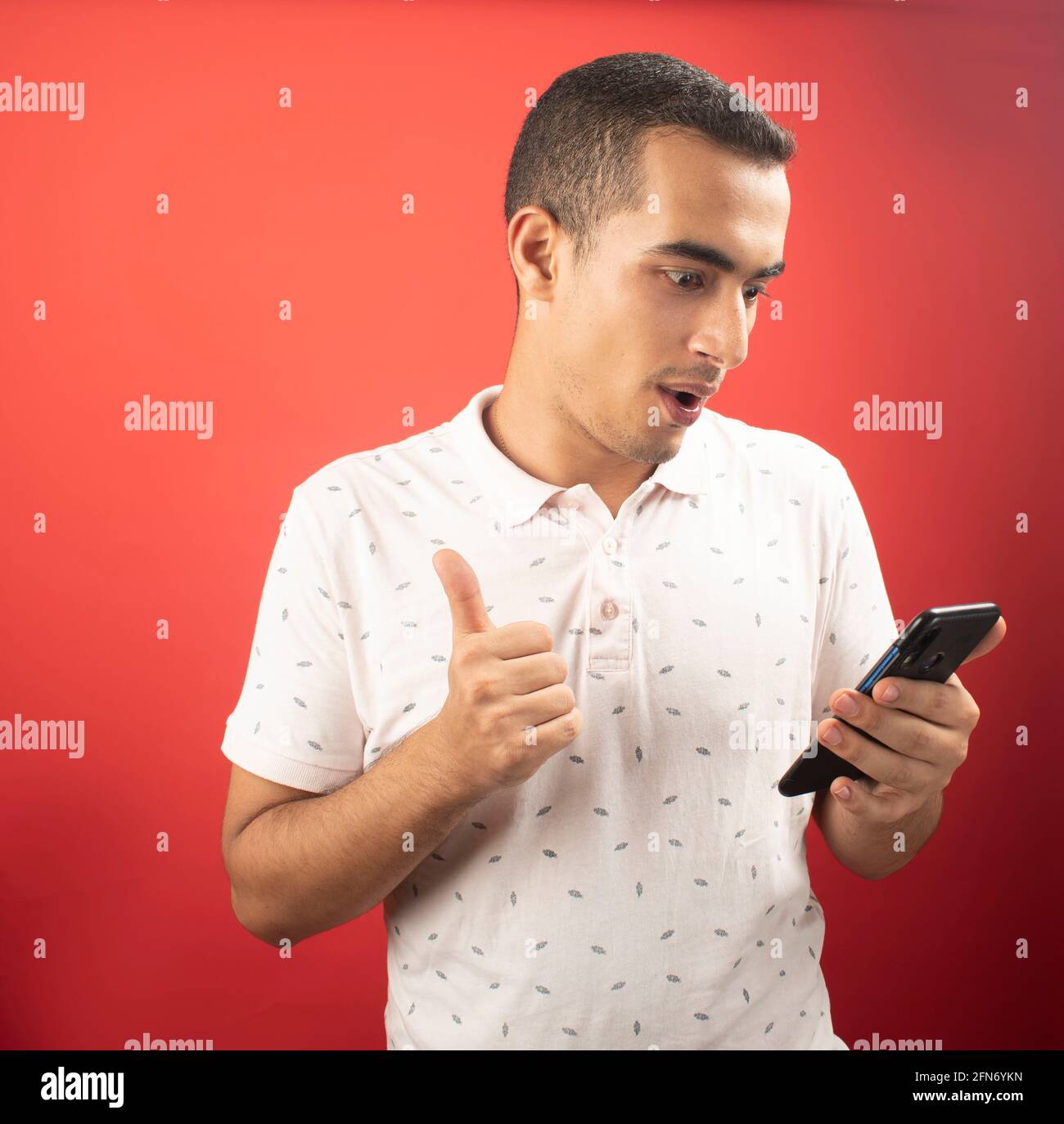a young man pointing at his phone Stock Photo - Alamy
