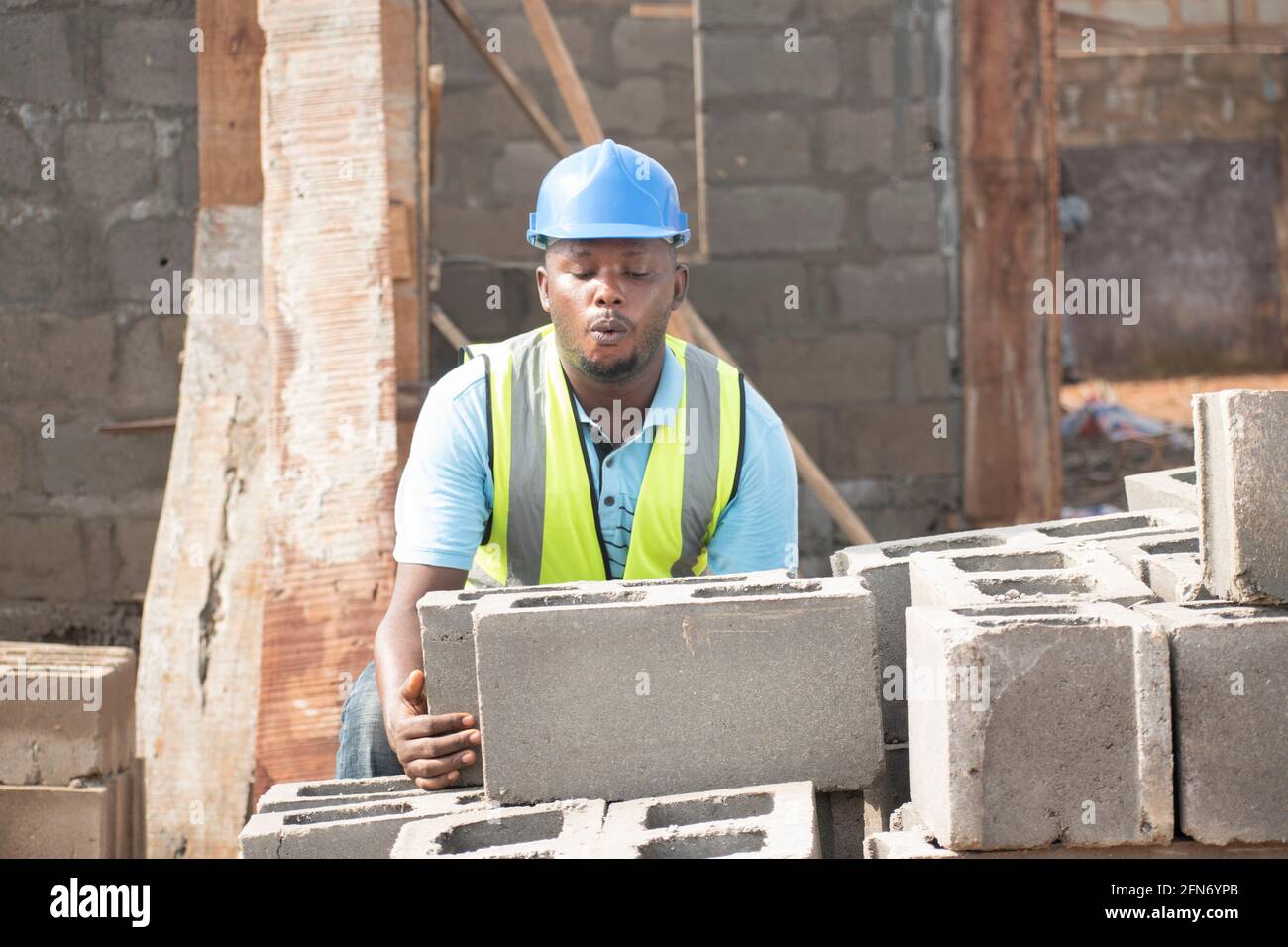 a building contractor lifting blocks on site Stock Photo - Alamy
