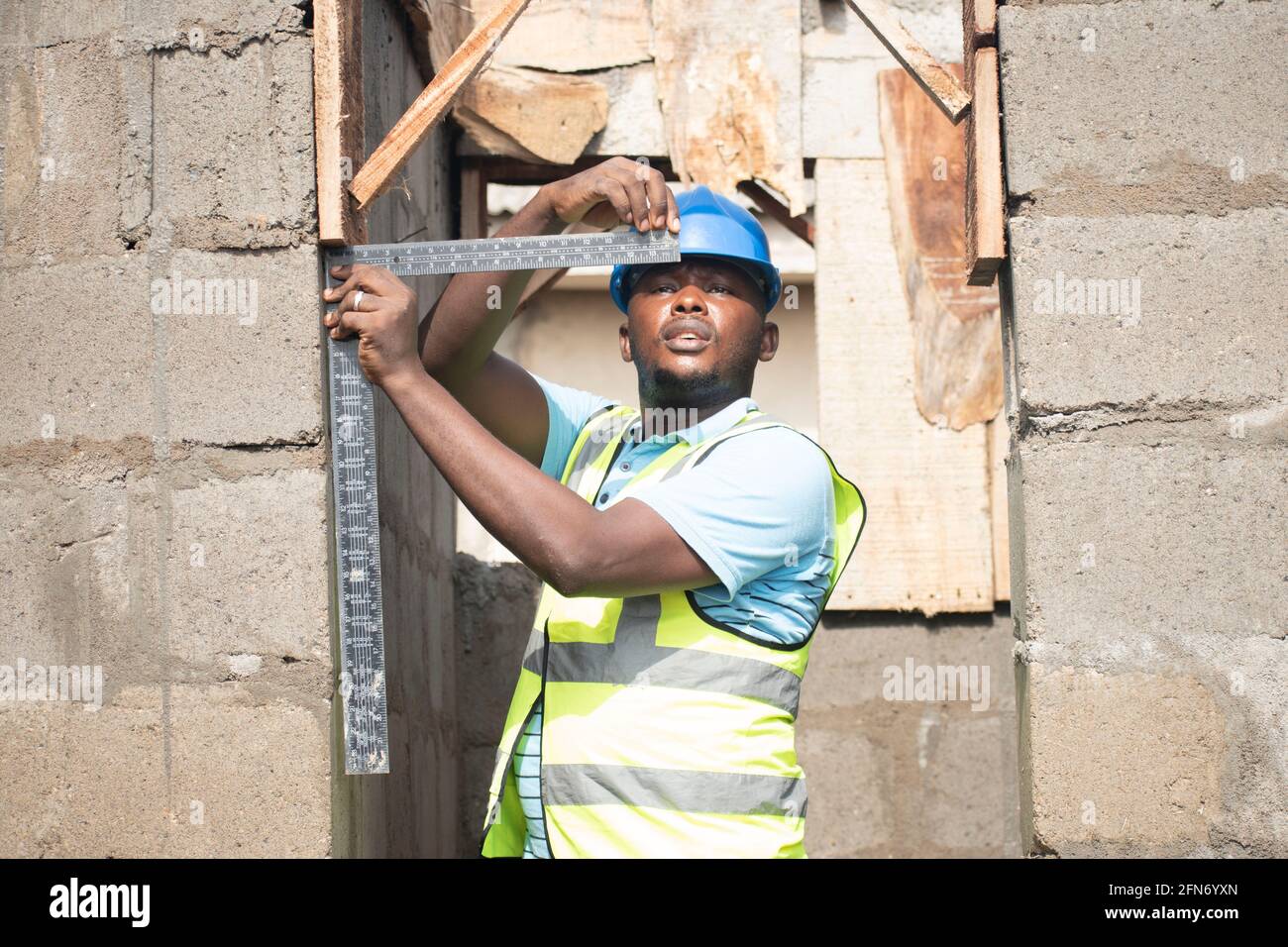 a building contractor using a square Stock Photo - Alamy