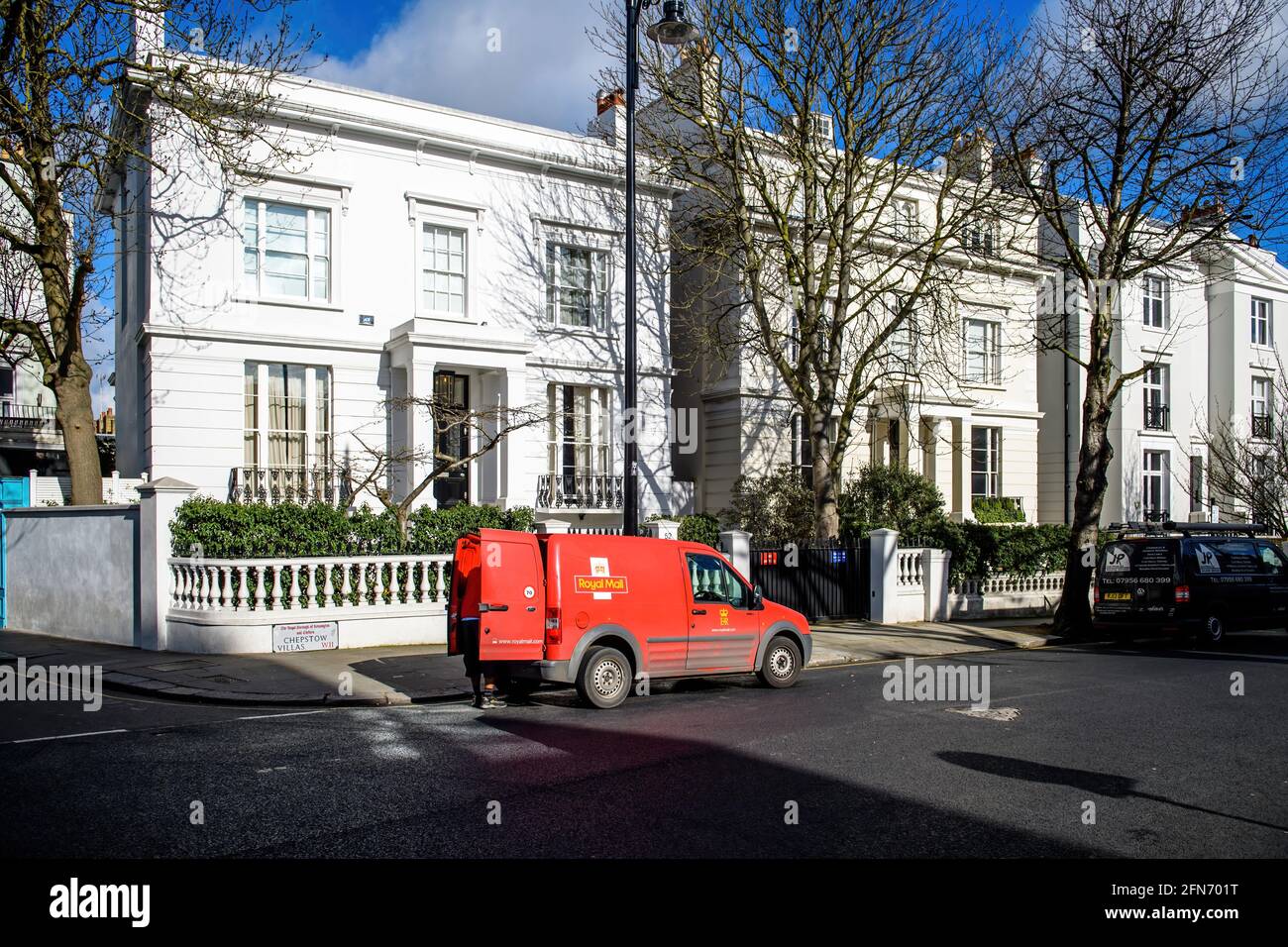 REd letter parcel delivery van from Royal Post Mail in front of luxury ...