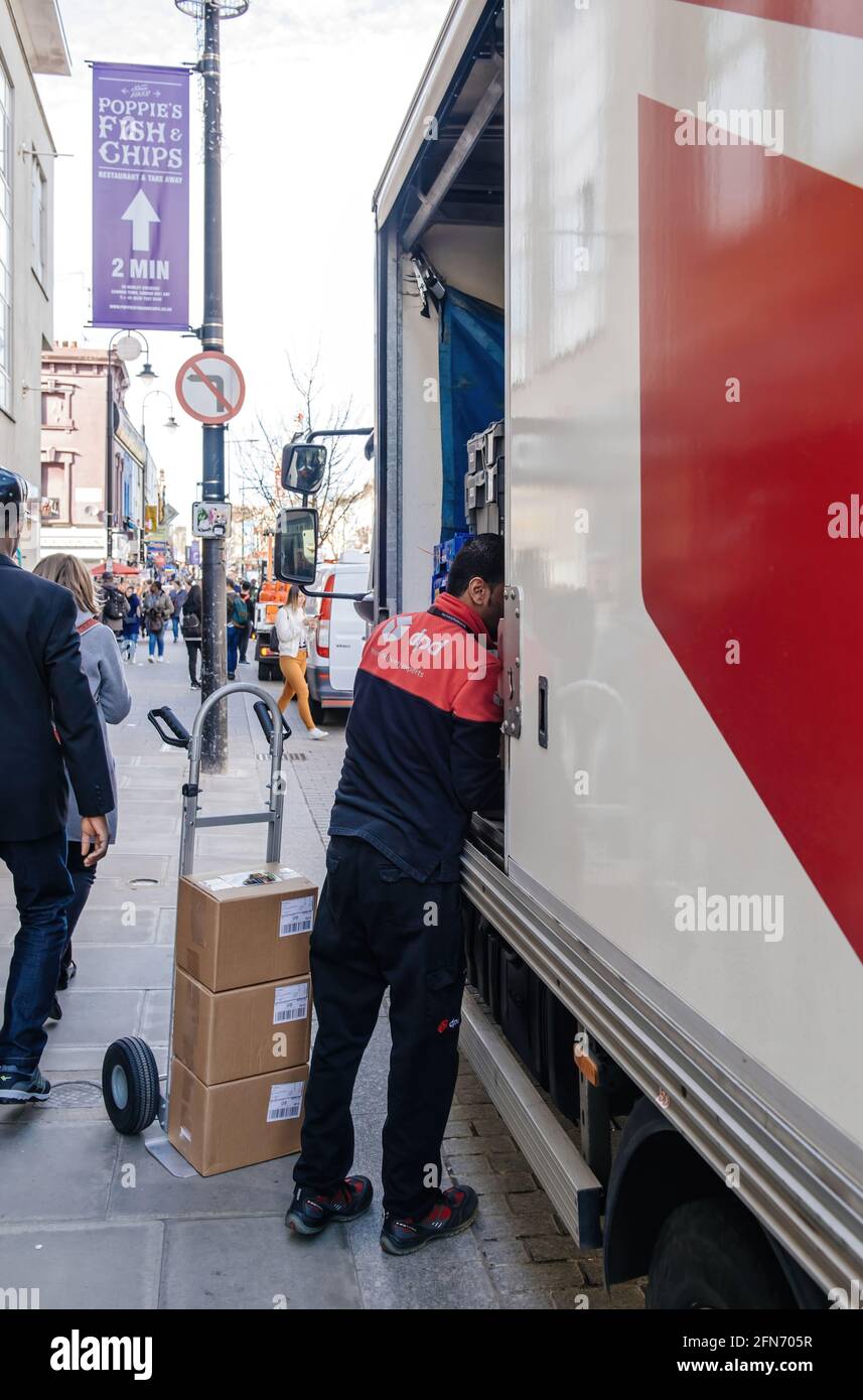 Rear view of DPD parcel delivery worker Stock Photo - Alamy