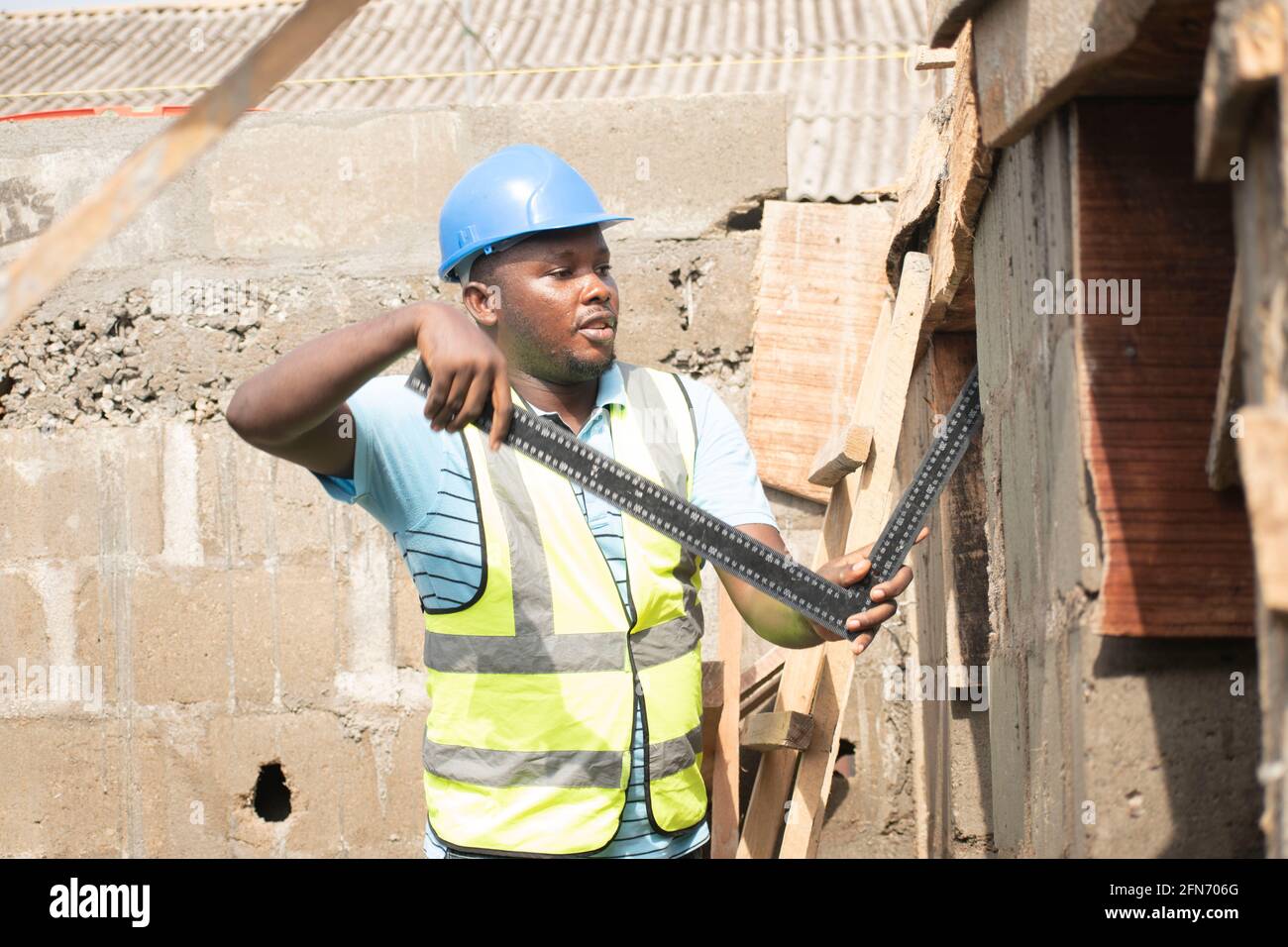 a building contractor using a square Stock Photo - Alamy