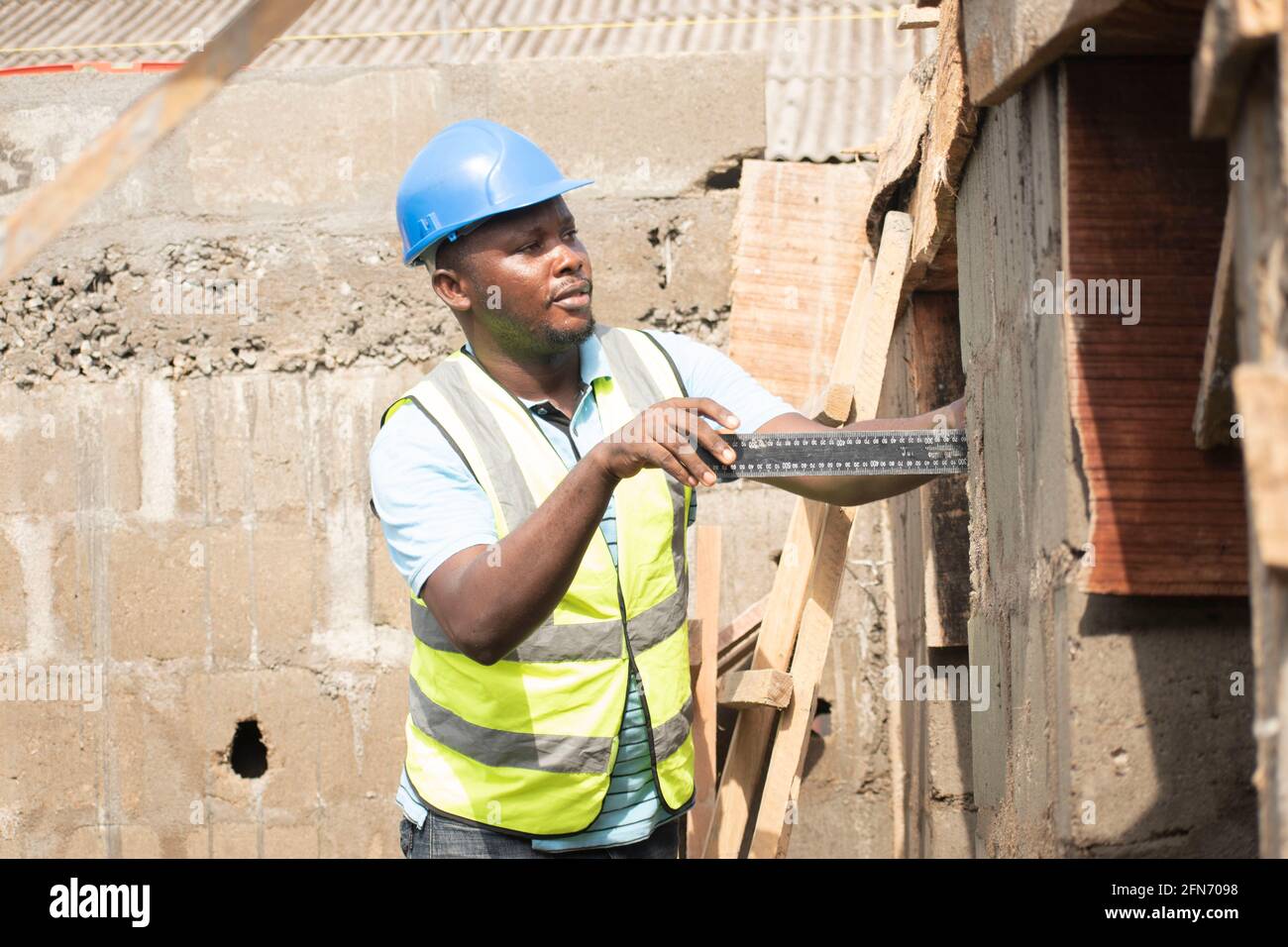 a building contractor using a square Stock Photo - Alamy