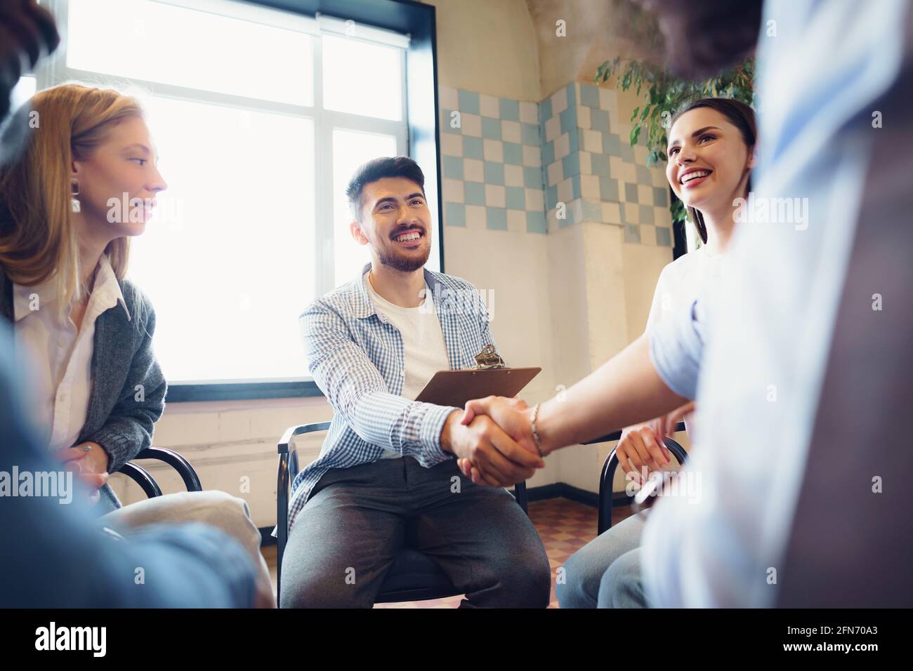 Young people sitting in a circle and having a discussion Stock Photo ...