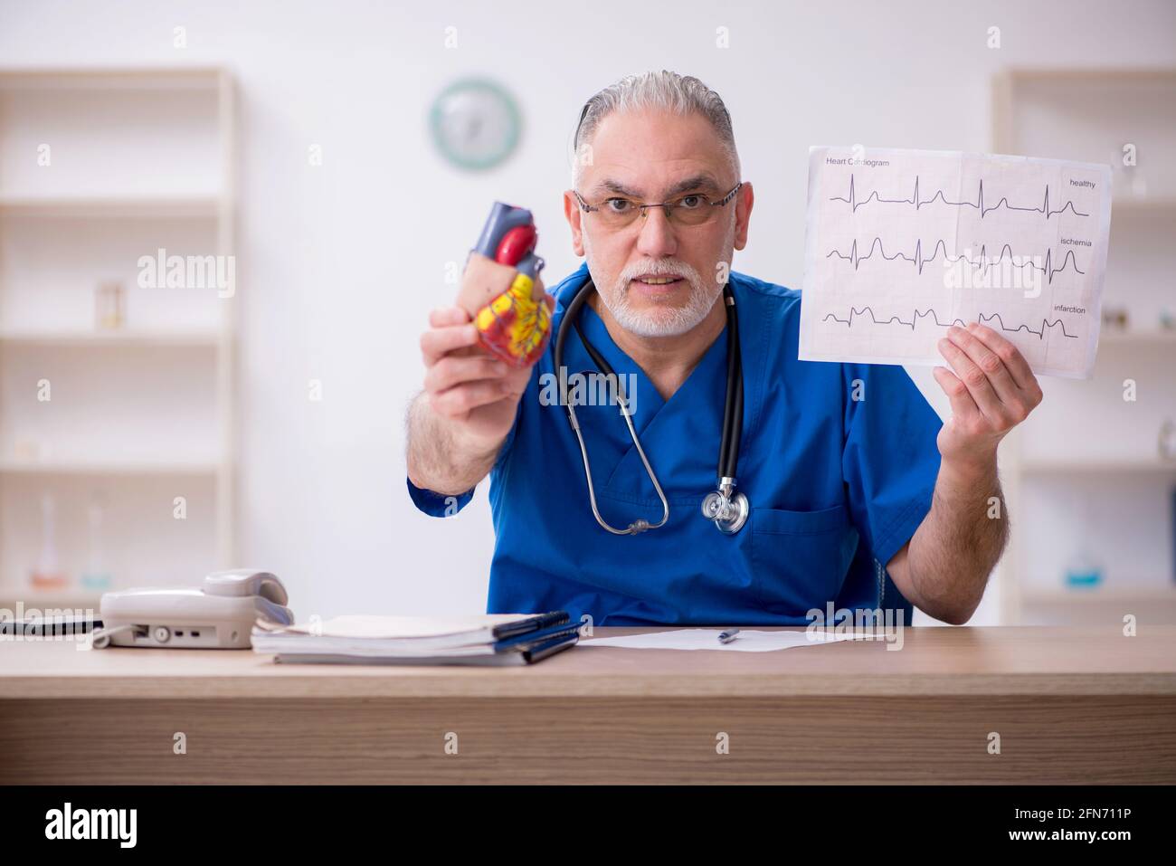 Experienced male doctor cardiologist working in the clinic Stock Photo ...